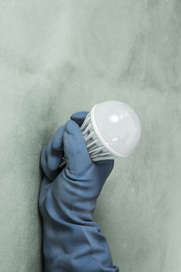 Blue Rubber Glove Holding Lamp Bulb Stock Image - Image of danger, wall ...