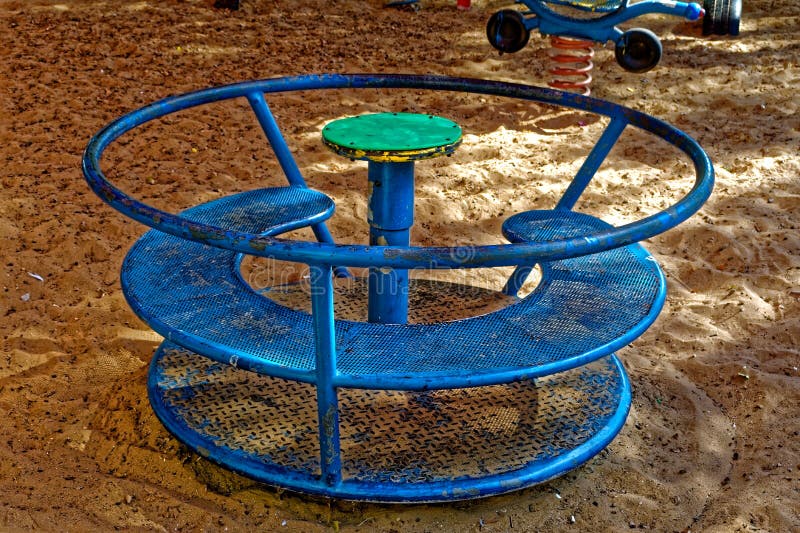 Rusty Playground Equipment with a Swingset Sits in a Courtyard of an ...