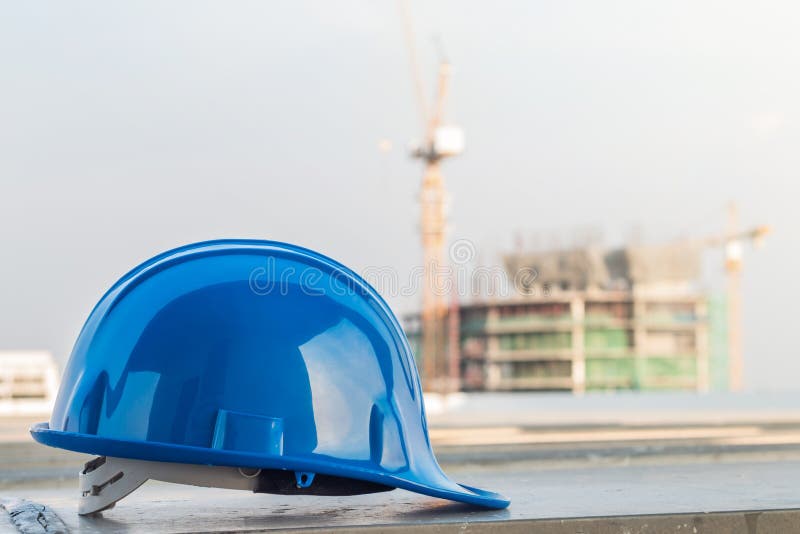 The Blue Safety Helmet at Construction Site with Crane Background Stock ...