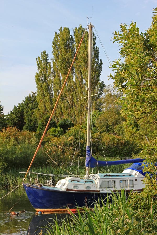 Blue Sailboat at River Frome, Wareham Stock Image - Image of sailboat ...