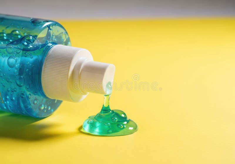 Blue Sanitizing Gel is Dripping from a Bottle Onto a Yellow Surface ...