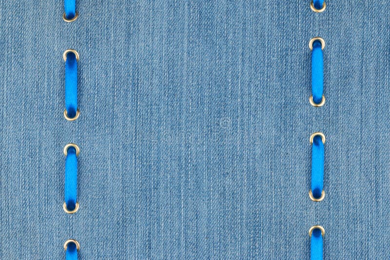 Blue Satin Ribbon Inserted in the Gold Rings on Denim Stock Image ...
