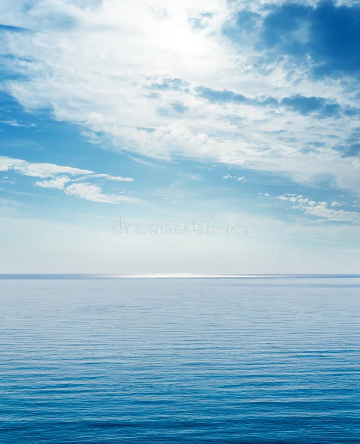 Blue Sea and Clouds with Sun Over it in Sky Stock Image - Image of ...