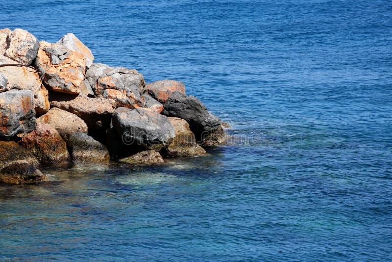 Blue sea and stones stock photo. Image of mediterranean - 128914186