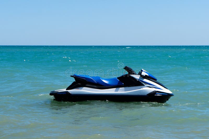 Blue Sea and a Jet Ski Floating on the Sea. Water Scooter is in the ...