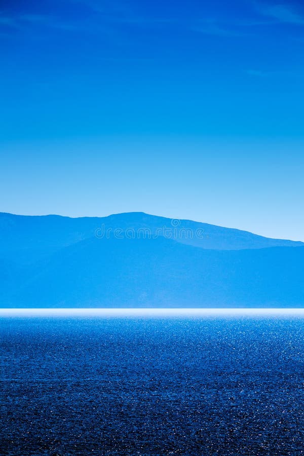 Blue Sea and Sky with Distant Mountains Stock Image - Image of beauty ...