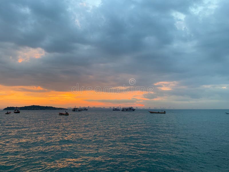 Blue sea, sun and gray sky stock photo. Image of gray - 134173110