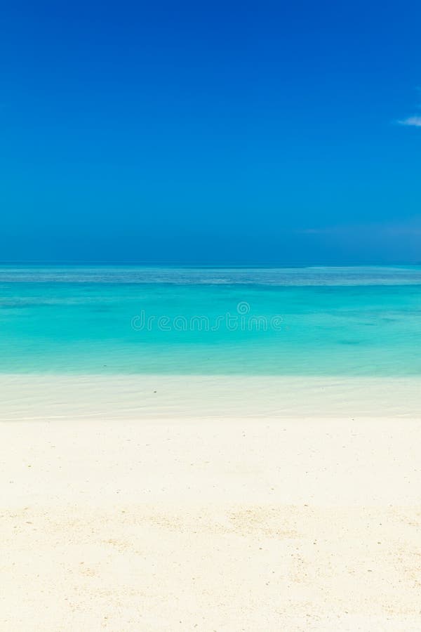 Blue Sea Water Surface, Clear Sky and Sandy Seashore Stock Photo ...