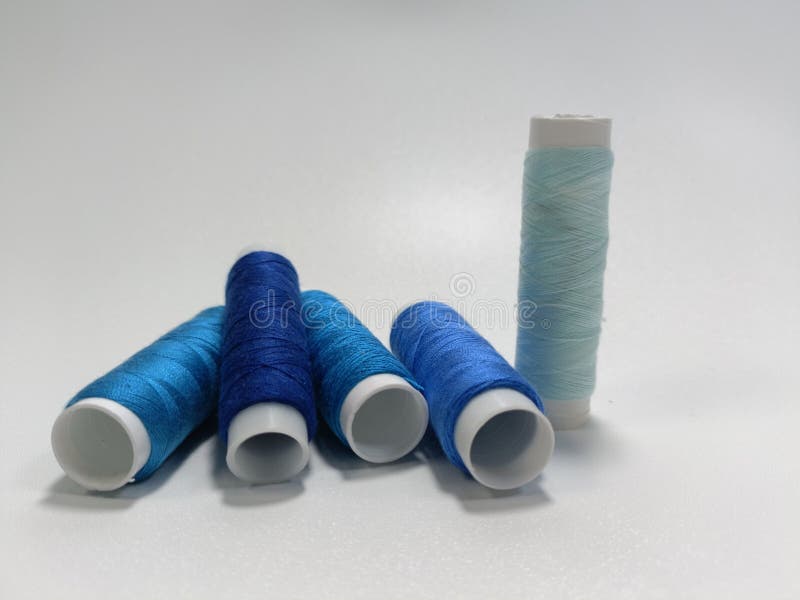 Blue Sewing Thread Spools with One Standing on White Background Stock ...