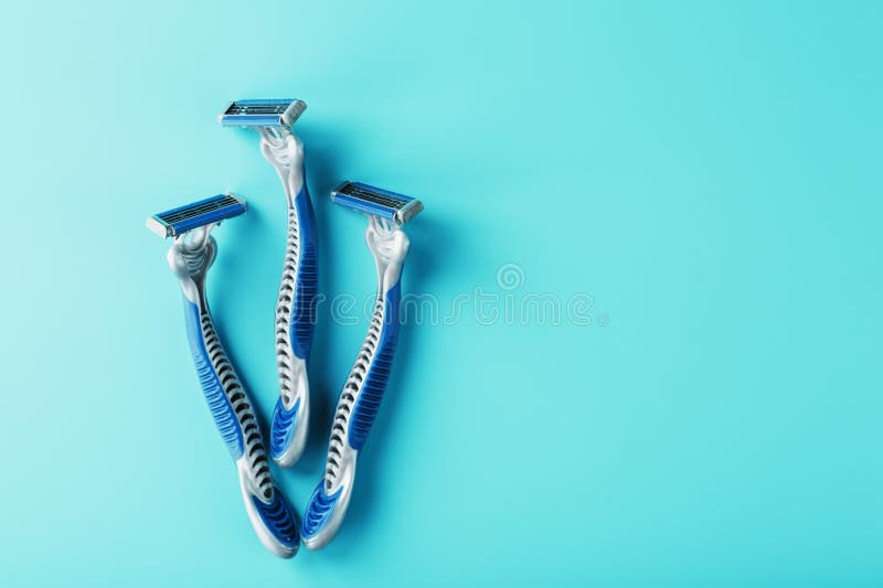 Blue Shaving Machines in a Row on a Blue Background with Ice Cubes ...