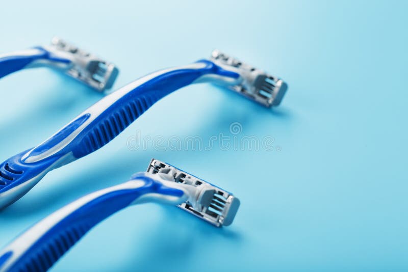 Blue Shaving Machines in a Row on a Blue Background with Ice Cubes ...