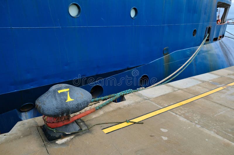 Topside of a Ship, Dock and a Mooring Bollard with Big Number Nine, 9 ...
