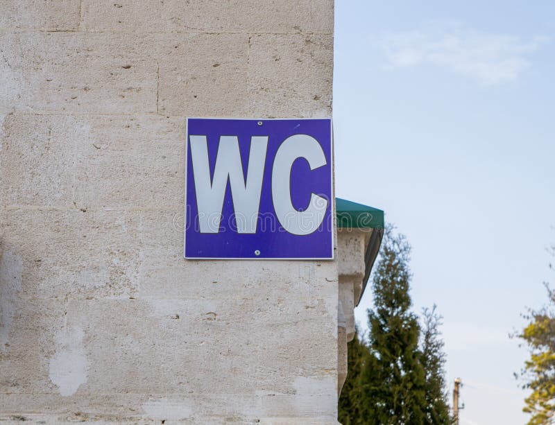 Blue Sign of Public Toilets WC on a Stone Wall Stock Image - Image of ...
