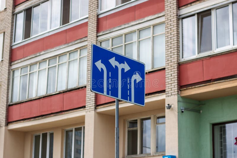A Blue Sign with Three Arrows Pointing in Different Directions Stock ...