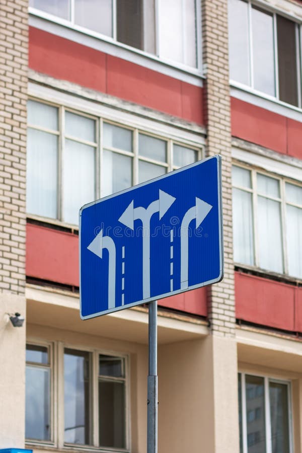 A Blue Sign with Three Arrows Pointing in Different Directions Stock ...