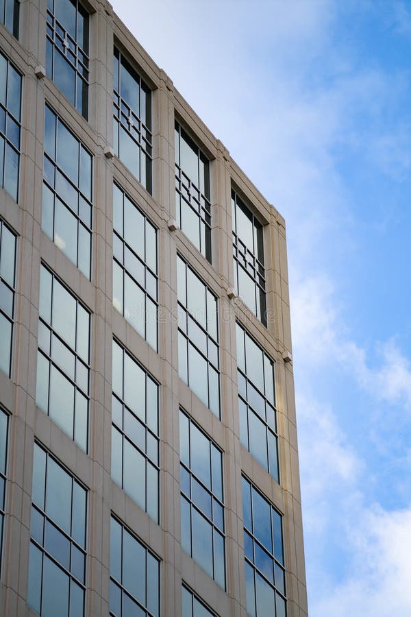 Blue Sky in Background with Building Filled with Windows in Foreground ...