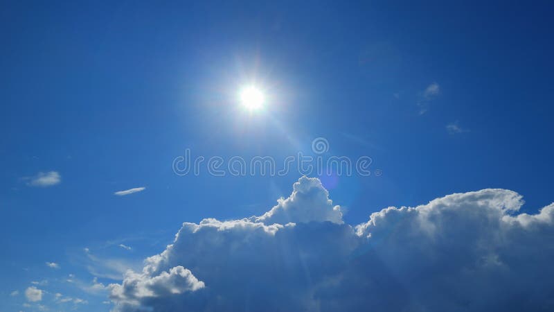 A Large Bright Sun on a Beautiful Blue Sky Above White Clouds. Stock ...