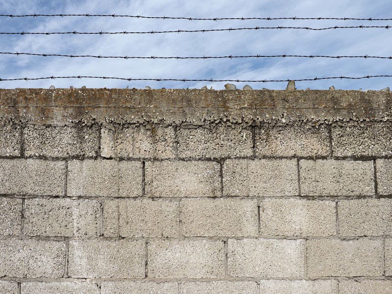 Blue Sky through Barbed Wire Fixed on a Concrete Wall Stock Image ...
