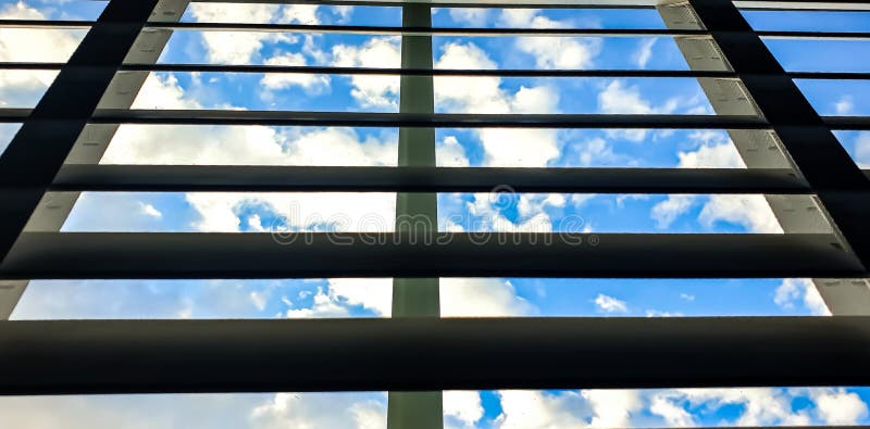 Blue Sky with Cloud Patterns through the Window Blinds Stock Photo ...