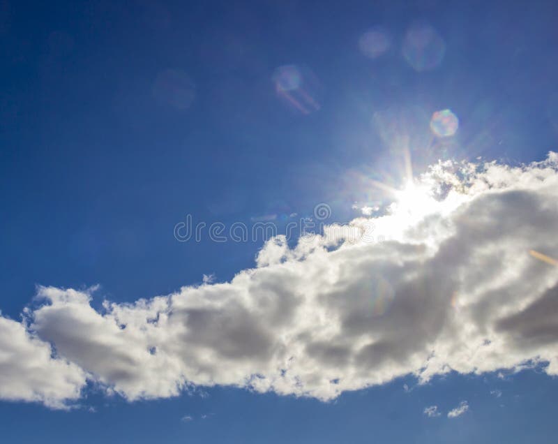 On a Blue Sky Clouds Horizontal Sun Bright Glare Beams Sparks Open ...