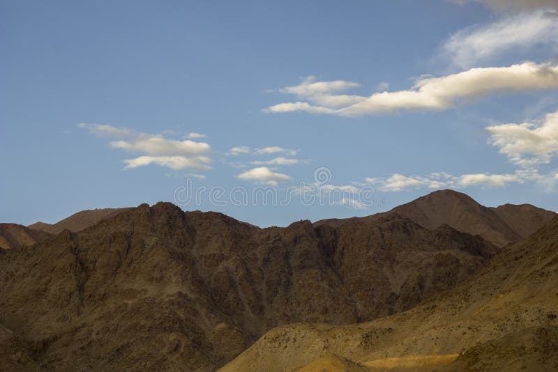 Blue Sky with Clouds Over the Sandy Mountains Stock Photo - Image of ...