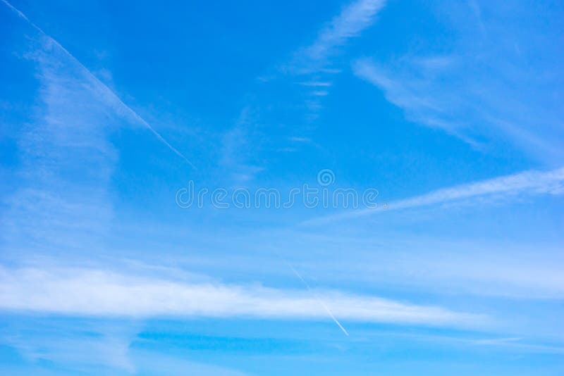 Blue sky with contrails stock image. Image of cloudscape - 90954139