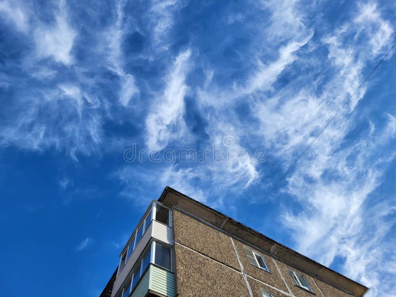 Blue Sky with Fluffy Feathery Clouds and the Edge of the Facade of a ...