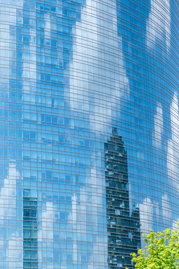 Blue Sky and Fluffy White Clouds Reflected in the Windows of Modern ...