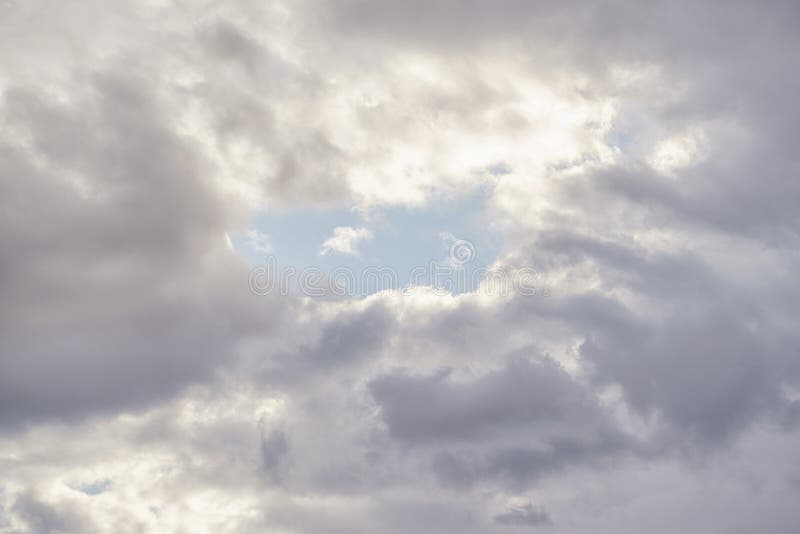 Blue Sky Gap in the Middle of White Rain Clouds Stock Photo - Image of ...