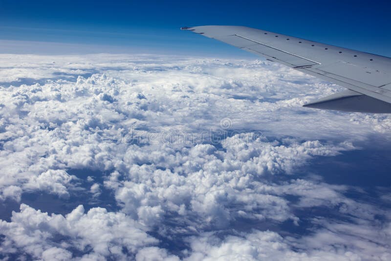Airplain Window Seat View of Big White Thick Fluffy Clouds with Stock ...