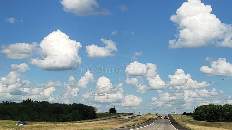 Blue Sky with Patchy Clouds and Long Country Road Stock Photo - Image ...