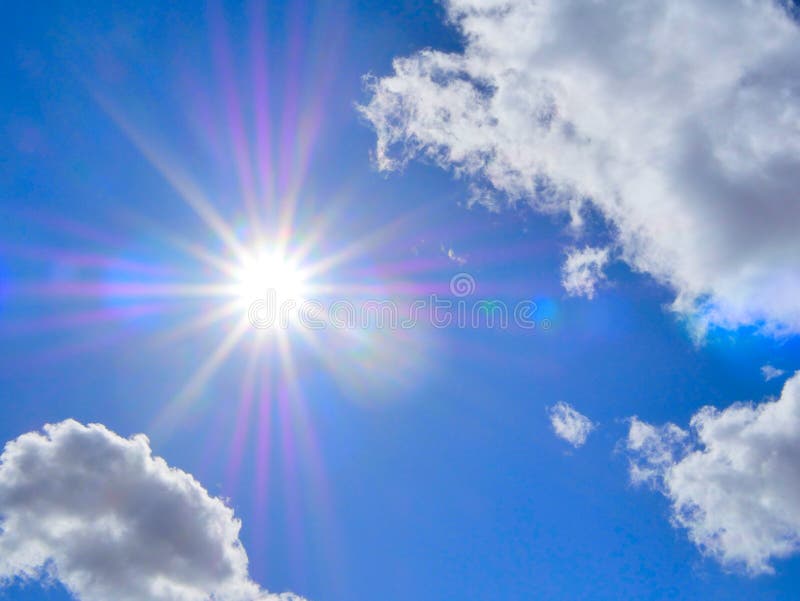 Blue Sky with Puffy White Clouds and Rays of Light from Sun. Stock ...