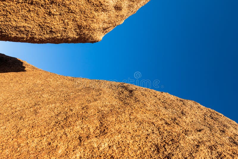 Blue Sky through Gap between Two Yellow Painted Rocks in the Colored ...