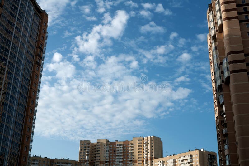 Blue Sky with Small Clouds between Homes Stock Photo - Image of ...