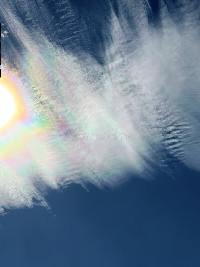 Blue Sky and Tiger Clouds with a Rainbow and a Ring of Bright Light ...