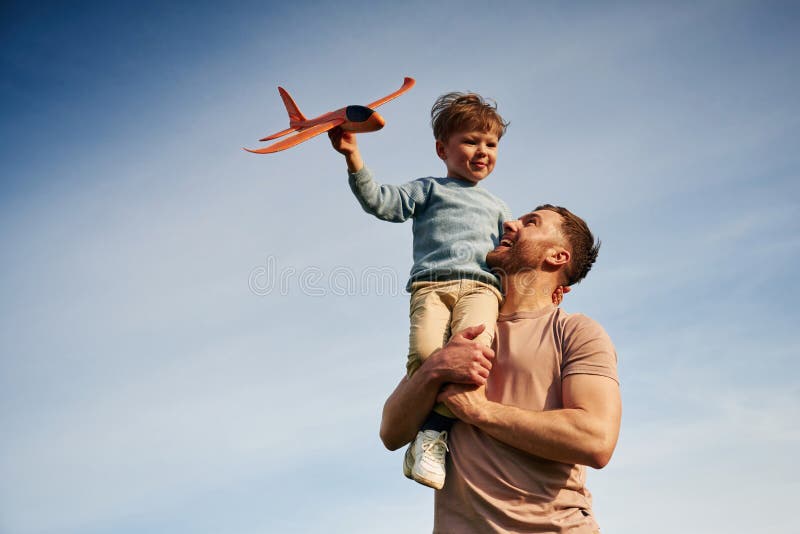 Blue Sky with White Cloud. Father is Holding Son that Playing with Toy ...