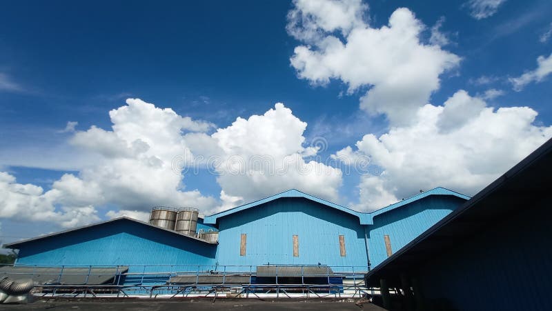 Blue Sky, White Clouds and Blue Factory Building Stock Photo - Image of ...