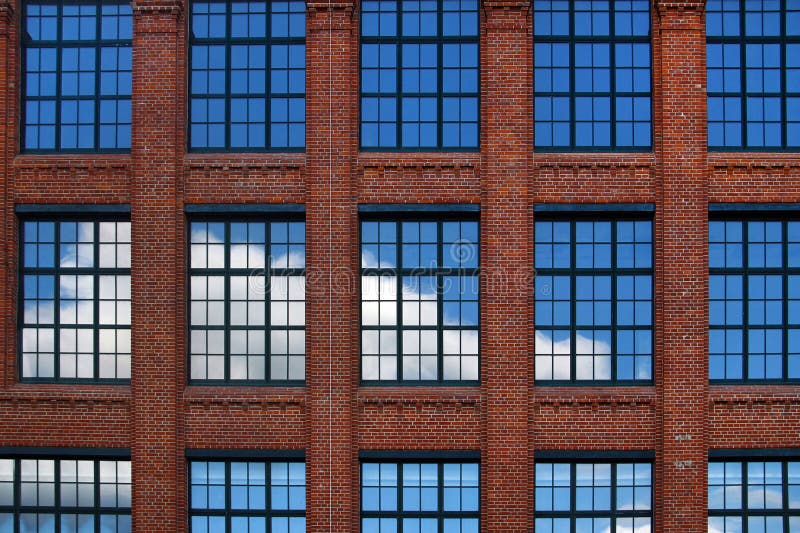 Blue Sky and White Clouds Reflection in Big Glass Windows in Red Brick ...