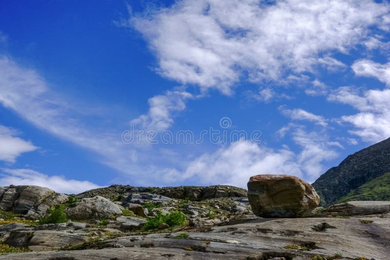 Blue Sky with White Clouds and a Single Rock on a Mountain Stock Photo ...