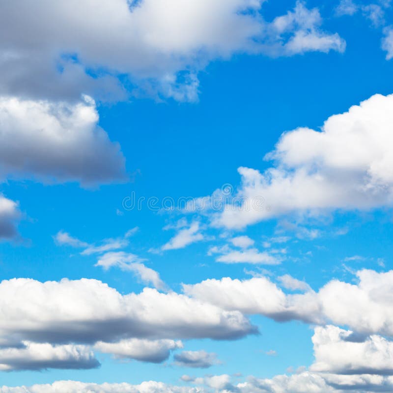 White Clouds on a Blue Sky. Delicate Fluffy White Clouds in the Sunlight Against a Blue Sky ...