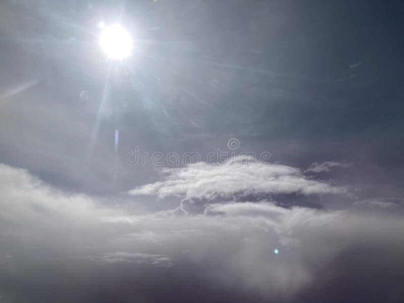 Blue Sky with White Smooth Clouds and the Big Bright Sun Rays Taken ...
