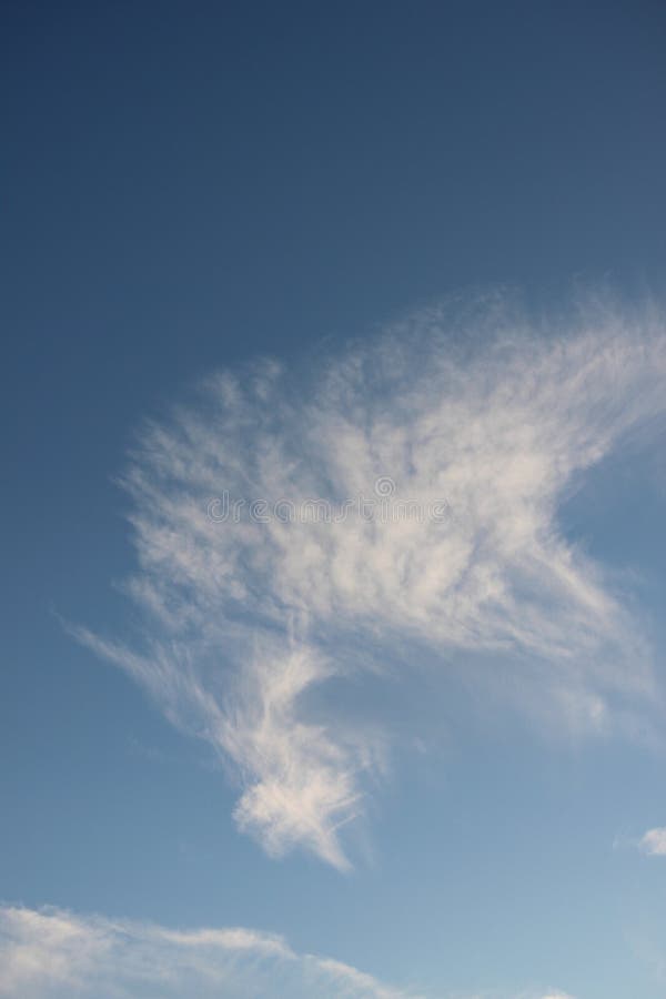 Blue Sky with a White Sweeping Monster Like Cloud Stock Photo - Image ...