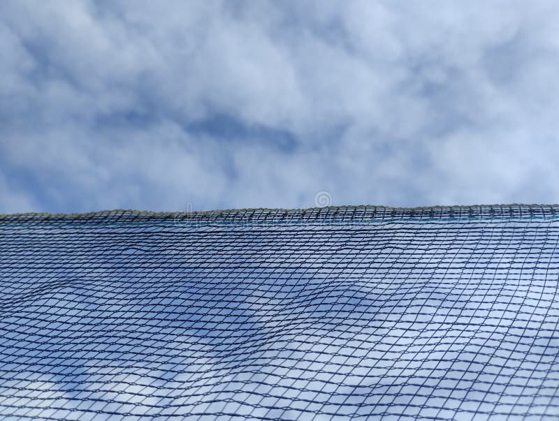 Blue Sky and Wisps of Clouds from Under the Net Stock Photo - Image of ...