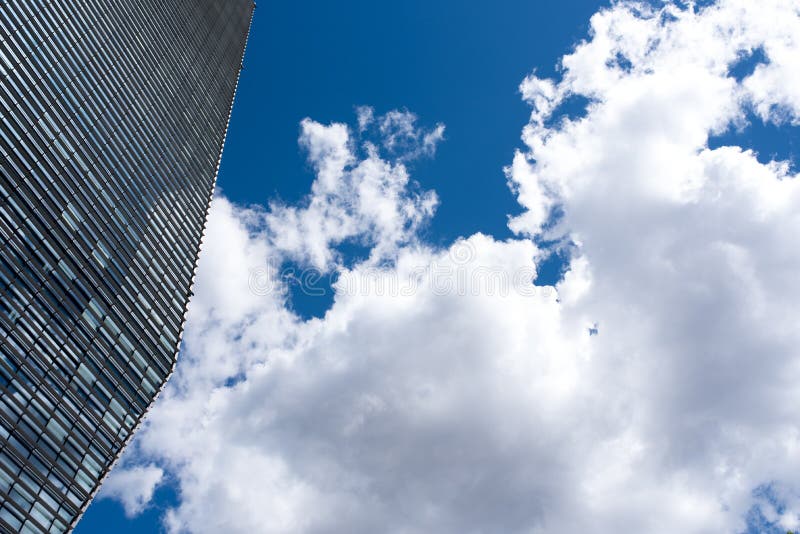 Blue Skyscraper with Reflections of Clouds on Windows Stock Image ...
