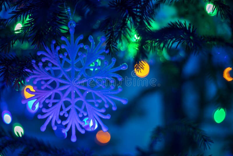 Blue Snowflake on a Tree with Yellow Garlands, Horizontal Format Stock ...