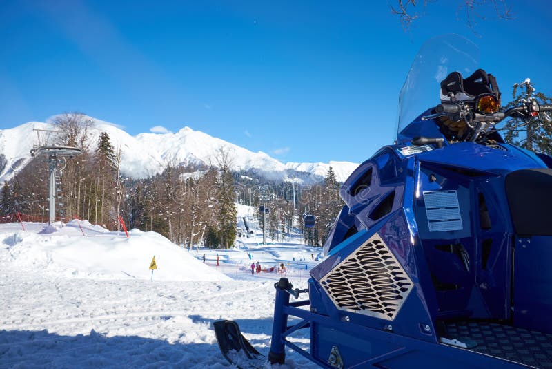 Blue Snowmobile on the Background of Snowy Mountains Stock Photo ...