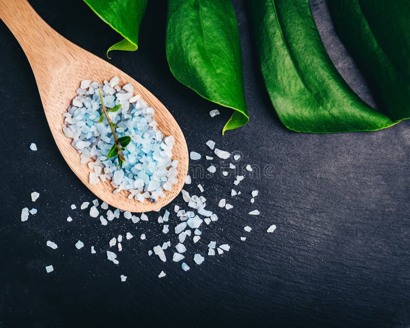 Blue Salt in Bamboo Spoon on Black Slate Plate with Monstera Leaf Stock ...