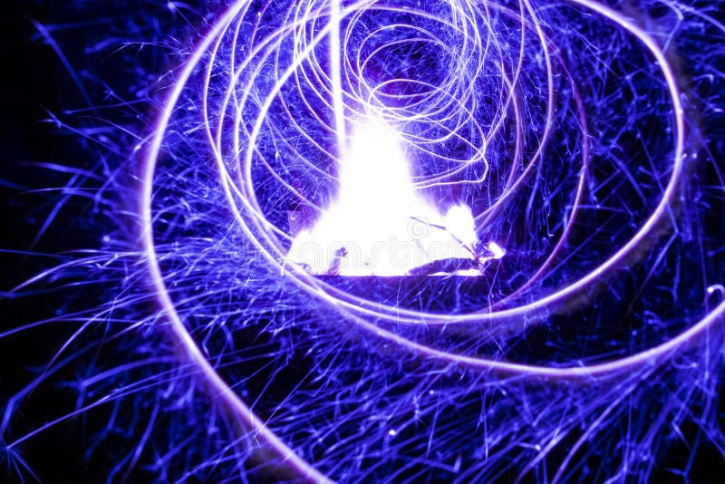 Blue Sparks of Fire Against a Dark Background Stock Photo - Image of ...