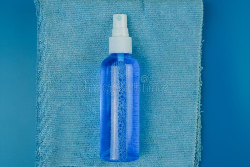 A Blue Spray Bottle Alongside a Cleaning Cloth All Presented on a ...