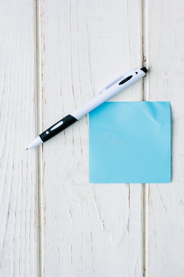 Blue Sticker and Pen Over White Surface Stock Photo - Image of logo ...